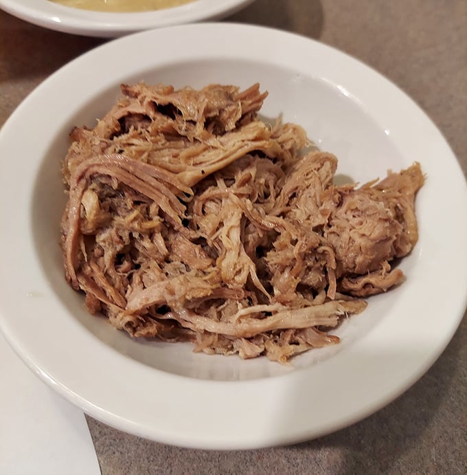Tender pulled pork that's spent hours getting acquainted with smoke and spices. No sauce needed &ndash; this meat has already found its best self.