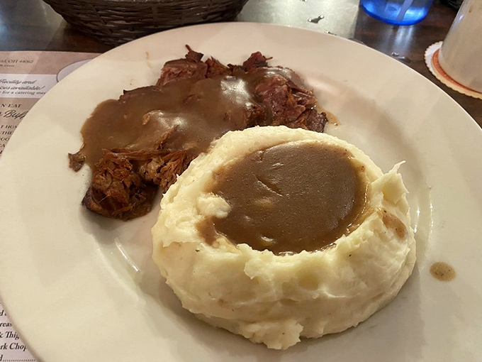 Roast beef so tender it practically surrenders to your fork, swimming in gravy that should be bottled and sold as therapy.