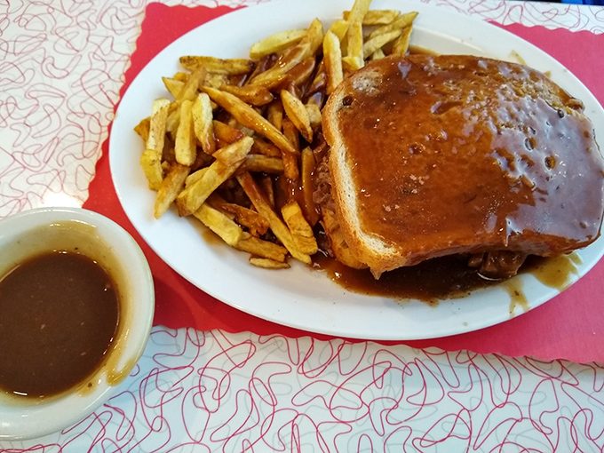 Not all heroes wear capes—some come smothered in gravy with a side of perfectly golden fries that crackle with each heavenly bite.