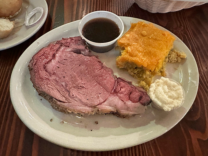 Prime rib so perfectly pink it could make a vegetarian question their life choices, served with that iconic square of tamale pie.