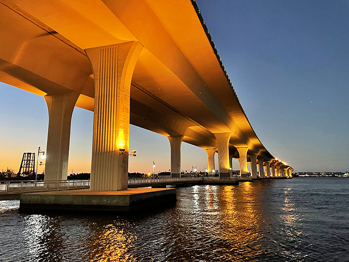 The Roosevelt Bridge glows at sunset like a golden pathway over calm waters, connecting Stuart's shores without the traffic nightmares of South Florida crossings.