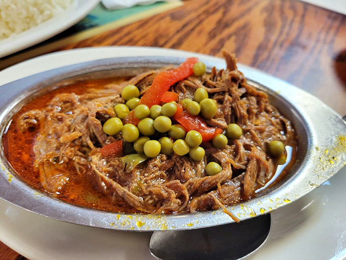 Ropa Vieja&mdash;"old clothes" that taste like new revelations. Shredded beef swimming in tomato sauce with green peas standing sentry.