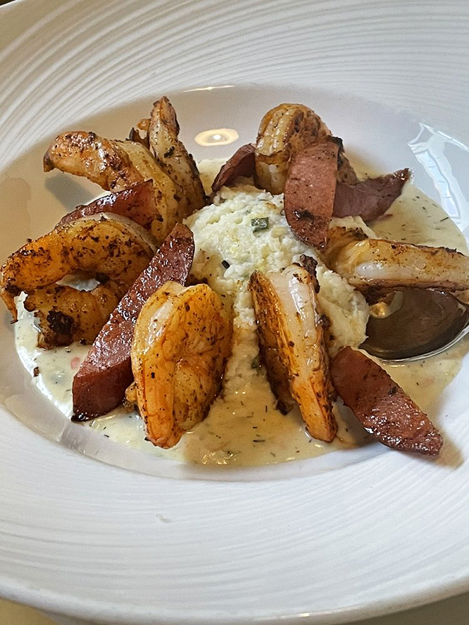 Shrimp and grits elevated to art form&mdash;plump shrimp surrounding creamy grits with andouille sausage creating a flavor symphony that would make New Orleans jealous.