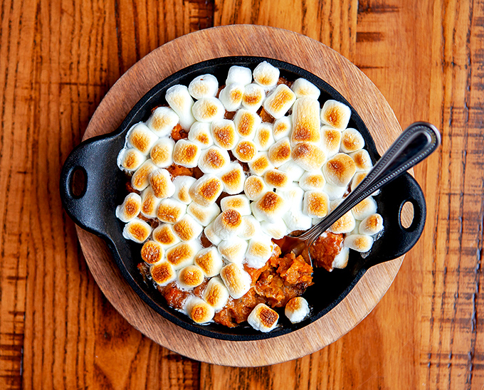 Sweet potato casserole masquerading as a side dish, with toasted marshmallows that take you straight back to childhood campfires.