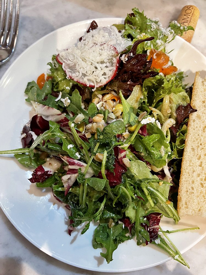 A salad that actually excites. Fresh greens, vibrant vegetables, and what appears to be goat cheese playing the role of delicious crown jewel.