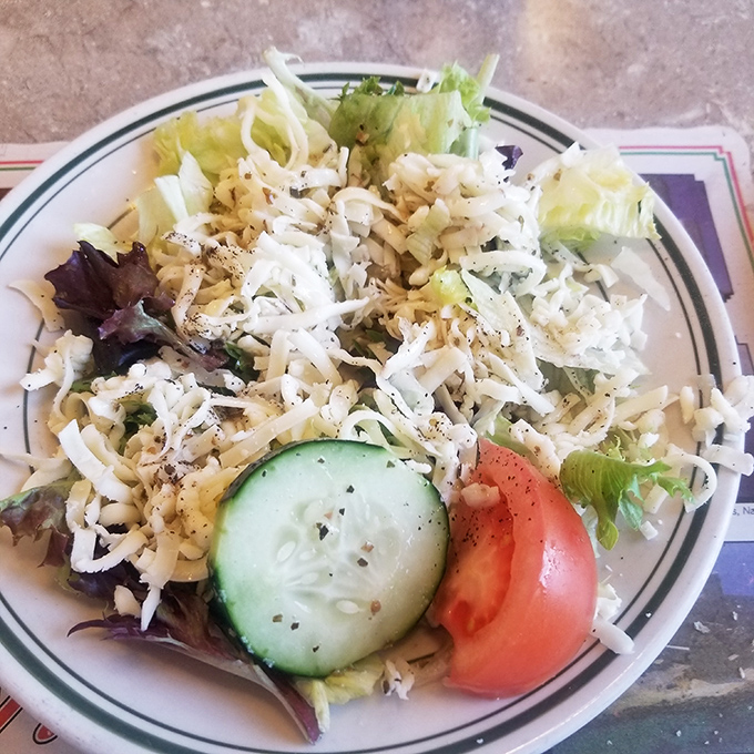 A house salad that actually deserves the name, with fresh vegetables providing the illusion that you're making healthy choices before the pizza arrives.