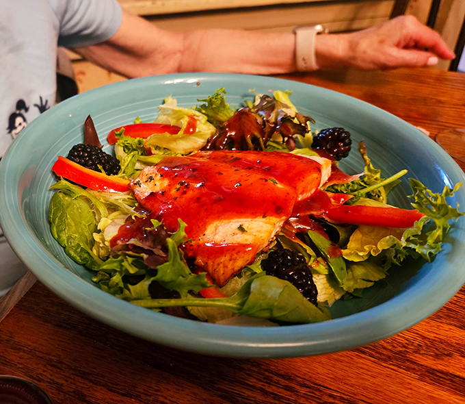 A salmon salad that proves healthy eating doesn't have to be punishment &ndash; vibrant greens, fresh berries, and perfectly cooked fish in harmonious balance.