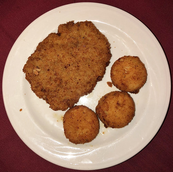 A schnitzel so perfectly golden and crisp, it makes you wonder if breading and frying might actually be the highest form of culinary art.