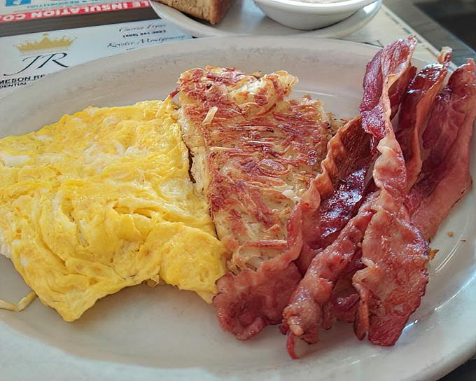 The classic American breakfast in all its glory &ndash; eggs cooked just right, bacon with that perfect crisp, and toast standing by for yolk-sopping duty.