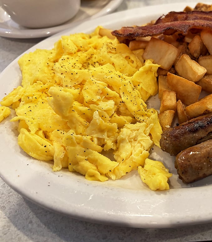 Scrambled eggs should be fluffy cumulus clouds on your plate. These look like they've achieved breakfast nirvana alongside those perfectly crisped home fries.