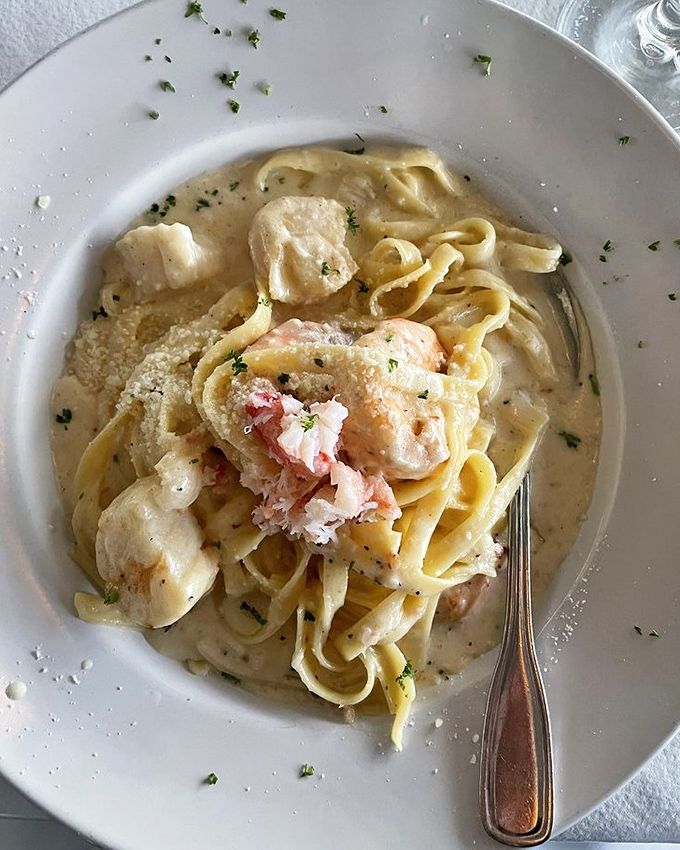 Seafood Alfredo that defies gravity &ndash; somehow rich yet light, with tender seafood playing hide-and-seek among perfectly cooked fettuccine ribbons.