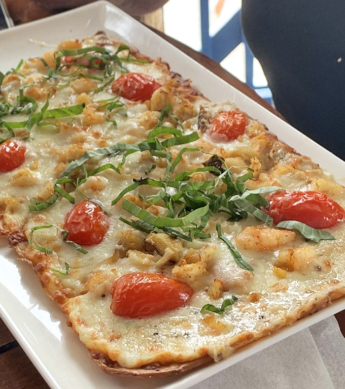 Ocean meets artistry on this flatbread canvas where shrimp, fresh herbs, and roasted tomatoes create a masterpiece worth framing&mdash;or devouring.