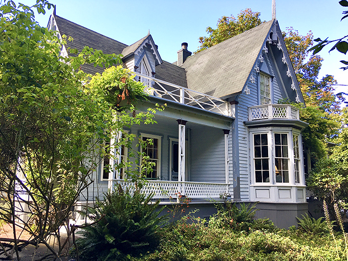 This blue Victorian beauty seems to float among the greenery, as if Mother Nature herself decided to accessorize around the architecture.