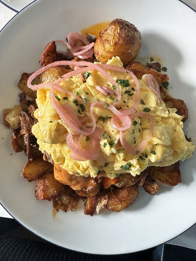 Scrambled eggs lounging atop crispy potatoes with pickled onions playing the role of the sassy friend who keeps the conversation interesting.