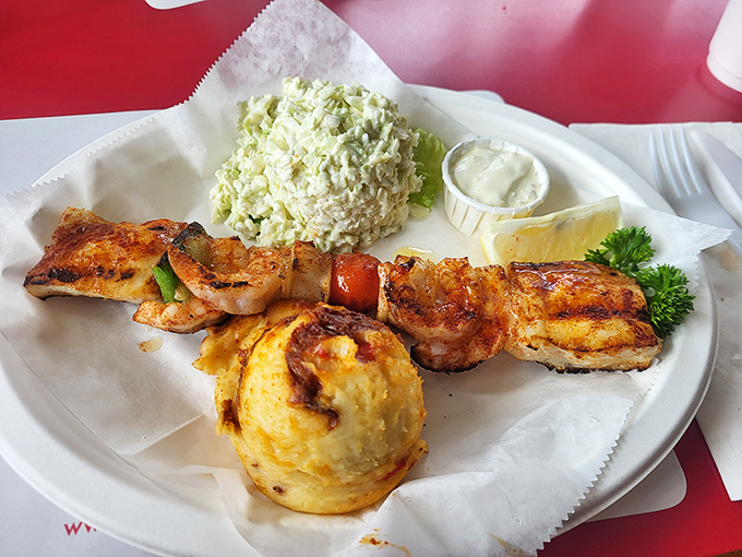 This skewer doesn't just hold seafood; it showcases a perfectly choreographed dance of flame-kissed shrimp alongside that famous coleslaw.