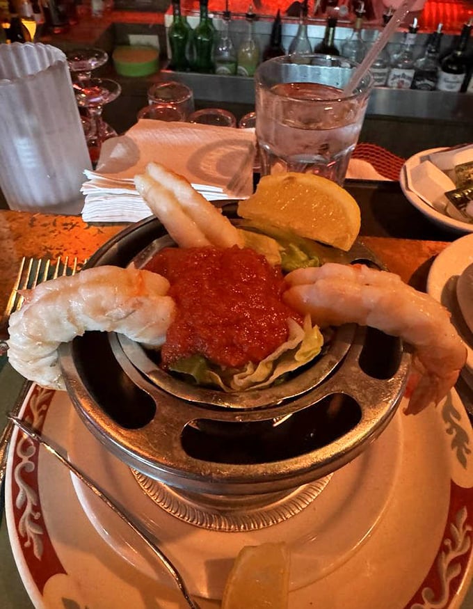 The shrimp cocktail – where plump crustaceans perch on the edge like divers contemplating the perfect plunge into zesty cocktail sauce.