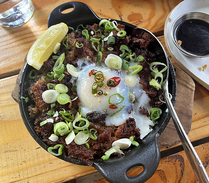 Sisig in a sizzling cast iron skillet - the Filipino comfort food that makes everything else seem ordinary.
