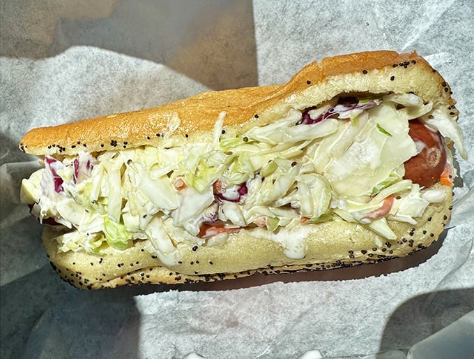 The slaw dog offers a cool, creamy counterpoint to the savory sausage beneath &ndash; like finding shade on a hot Florida afternoon.