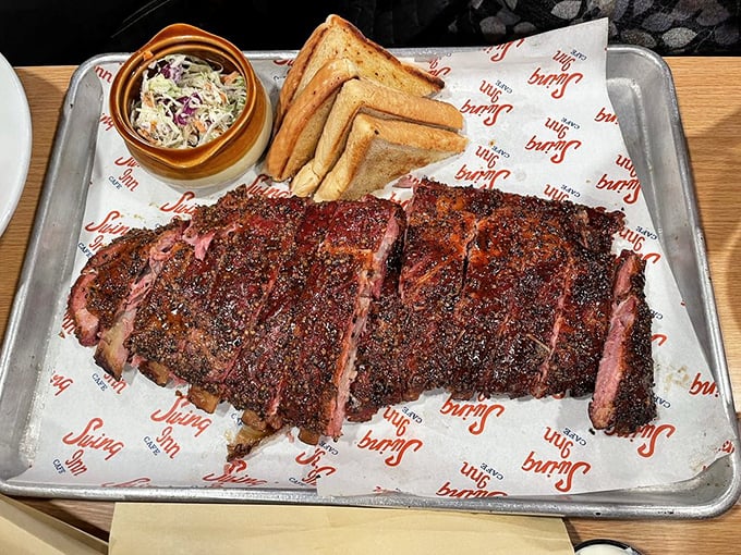 Barbecue so serious it comes on a metal tray&mdash;smoke-kissed ribs with that perfect bark that makes conversation stop and napkins necessary.