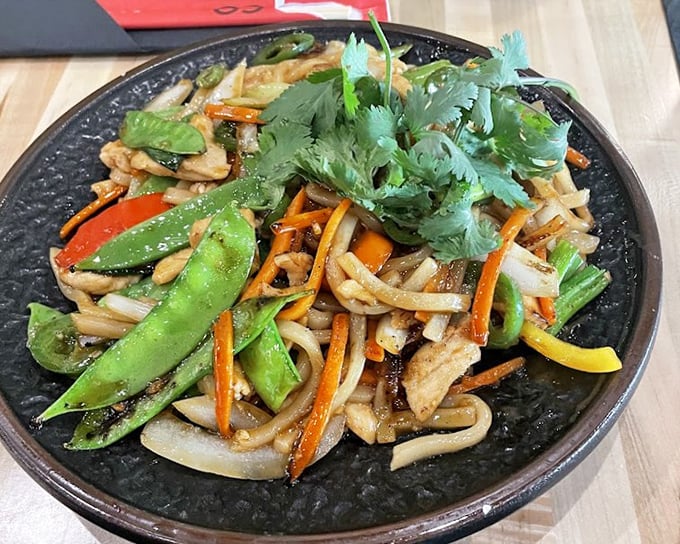 Stir-fried udon with vibrant vegetables&mdash;proof that eating your greens can be an adventure rather than a chore your mother nagged about.
