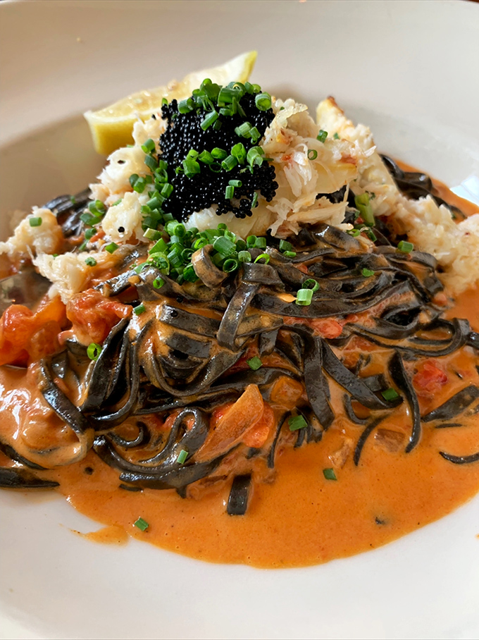 Squid ink pasta isn't just dramatic to look at&mdash;it's a flavor bomb of seafood goodness topped with delicate crab and bathed in tomato cream sauce.