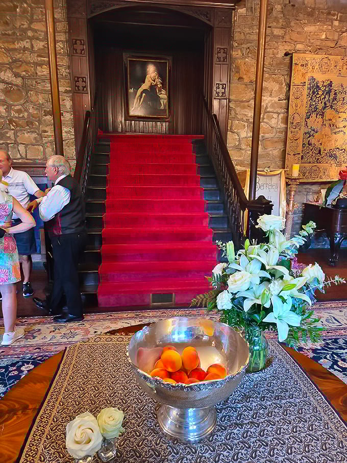 The grand staircase beckons visitors upward with its crimson carpet&mdash;the medieval equivalent of a VIP entrance to history.