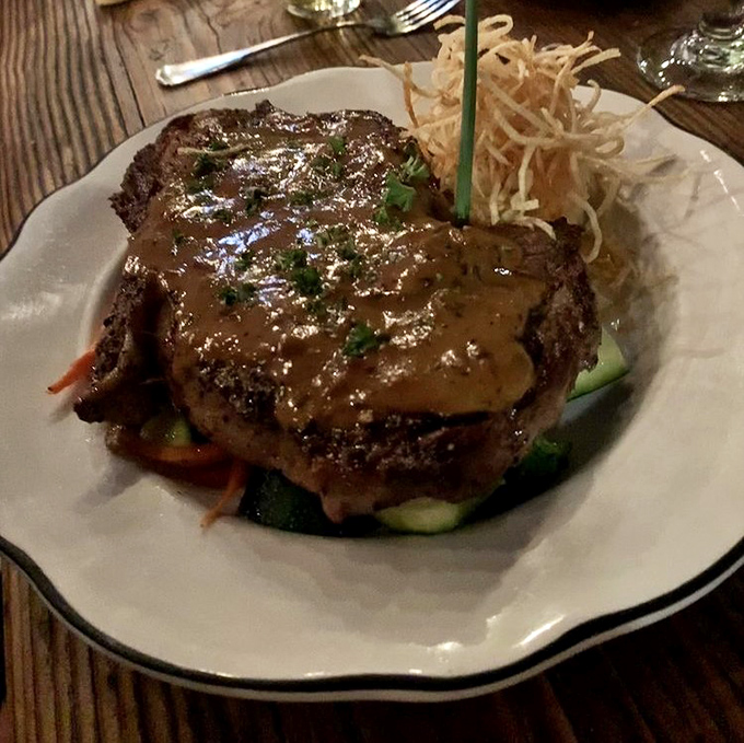 Not just a steak, but a declaration of love to beef &ndash; perfectly seared, sauced with reverence, and garnished with crispy shoestring potatoes.