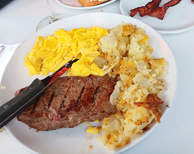 The breakfast of champions: a perfectly seared steak alongside fluffy scrambled eggs and home fries that could make a potato farmer weep with pride.