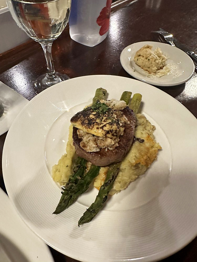 This steak topped with seafood and asparagus is what happens when surf meets turf and they decide to throw a party on your plate.