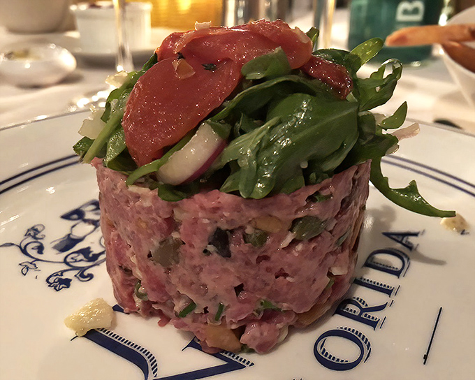 Steak tartare that's dressed better than most people at the opera&mdash;a symphony of flavors topped with delicate greens.