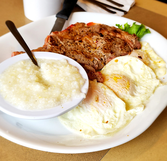 The breakfast of champions isn't cereal—it's a perfectly seared steak alongside sunny eggs and grits. Protein paradise on a plate.