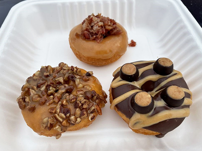 The holy trinity of donut indulgence: caramel-pecan, maple-pecan, and chocolate-peanut butter. A flavor trifecta that makes decision-making deliciously difficult.