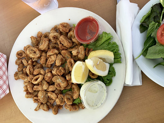 These crispy calamari pieces aren't just fried &ndash; they're transformed into addictive morsels that disappear faster than beach parking on July 4th.