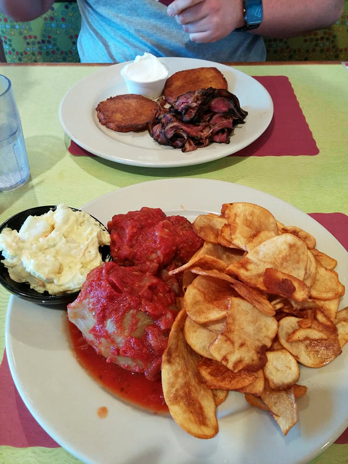 Stuffed cabbage swimming in bright tomato sauce with homemade potato chips standing guard. Comfort food that speaks with a slight Eastern European accent.