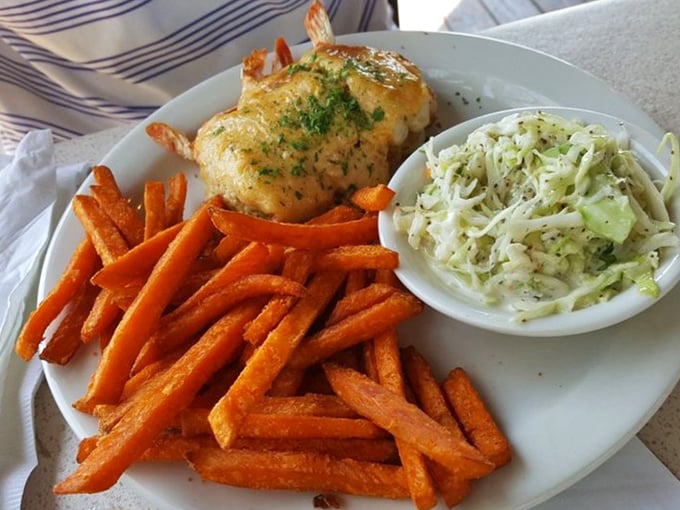 When one seafood treasure isn't enough – a crab cake perched atop sweet potato fries with coleslaw standing by for textural contrast.