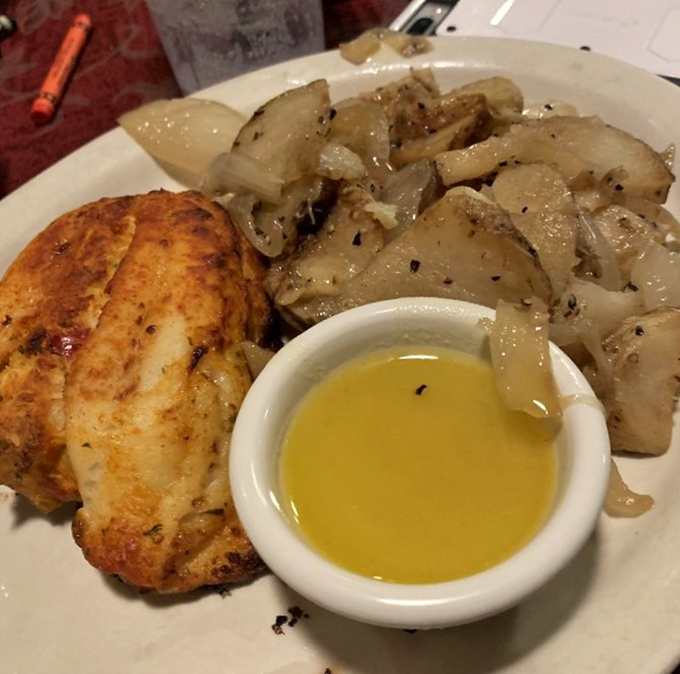 Simple perfection on a plate – tender stuffed flounder, sautéed onions, and a side of melted butter that makes everything it touches turn to culinary gold.