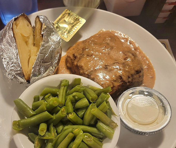 A dinner plate that tells the whole Midwest story: tender meat, garden-fresh green beans, and gravy that demands to be savored, not rushed.