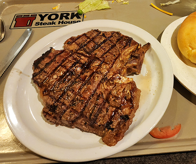The T-bone steak arrives with perfect grill marks that say, "I've been cooking since before Instagram food photos were a thing."