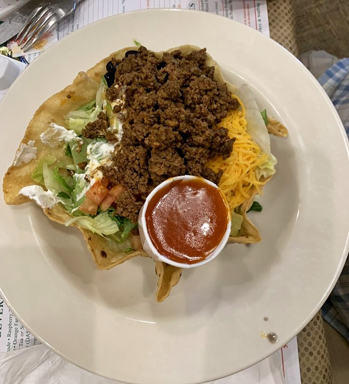 A taco salad that refuses to be contained by conventional bowls, instead creating its own edible fortress of flavor.