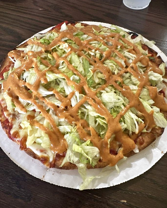 The taco pizza breaks all the rules in the best possible way. Crisp lettuce and that signature sauce drizzle create a fiesta for your taste buds.