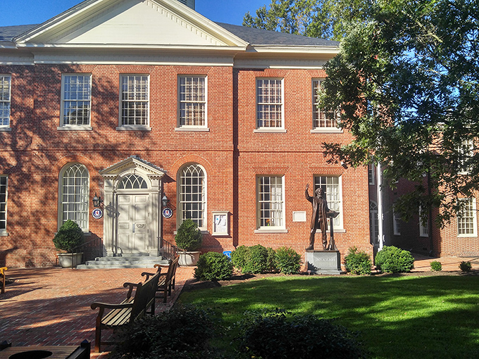 The Talbot County Courthouse stands proudly on manicured grounds, a red-brick reminder that justice and beauty can indeed share the same address.