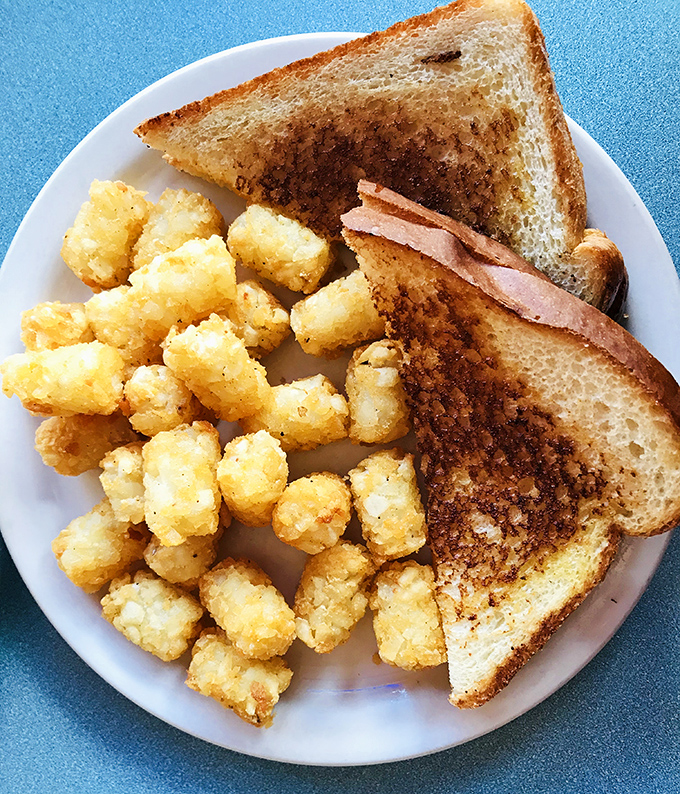 Tater tots and toast &ndash; the breakfast buddy comedy we didn't know we needed. One crunchy, one buttery, both absolutely essential to morning happiness.