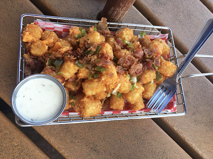 These aren't your cafeteria tater tots. Golden-brown, bacon-topped, and ready for their close-up—comfort food elevated to art form.