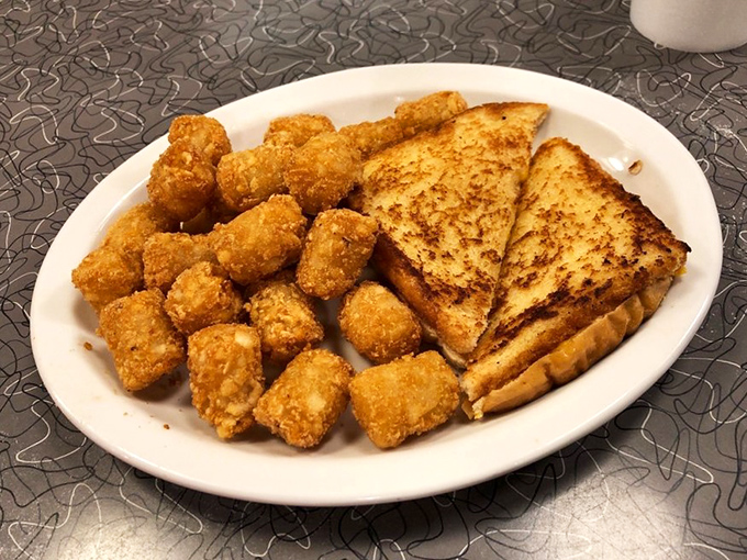 Golden-brown tater tots and a grilled cheese sandwich—childhood comfort reimagined for your adult appetite. Nostalgia never tasted so good.