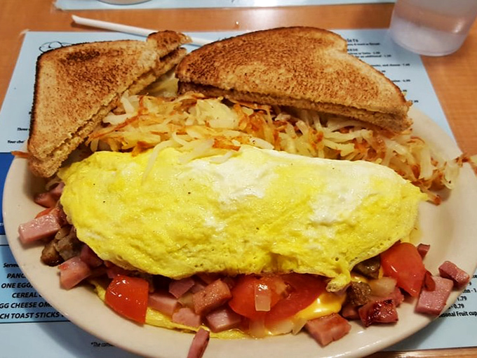 This omelet doesn't just contain ingredients—it embraces them in a fluffy yellow hug that makes vegetables feel welcome at breakfast.