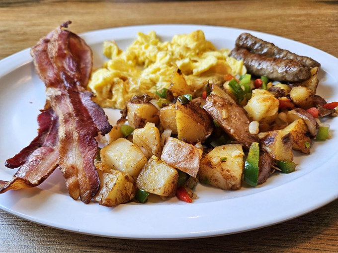 The breakfast trifecta: crispy potatoes, fluffy eggs, and bacon cooked to that magical point between chewy and crisp. Morning perfection on a plate.