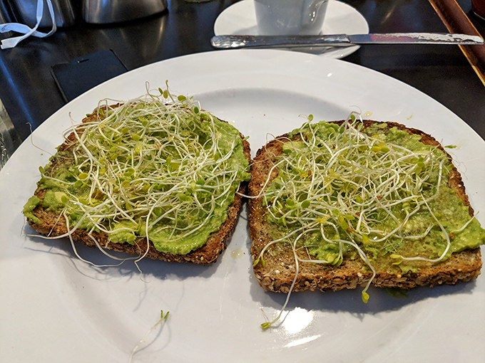Avocado toast that Instagram was invented for&mdash;where creamy green goodness meets delicate sprouts on hearty bread. Simple ingredients, executed brilliantly.