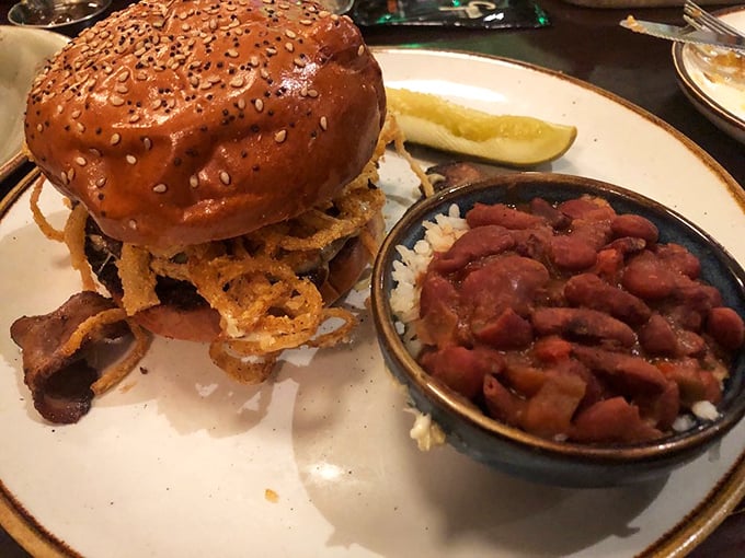 This isn't just a sandwich; it's architecture. The sesame bun foundation supports a masterpiece of meat, with those beans standing by for backup.