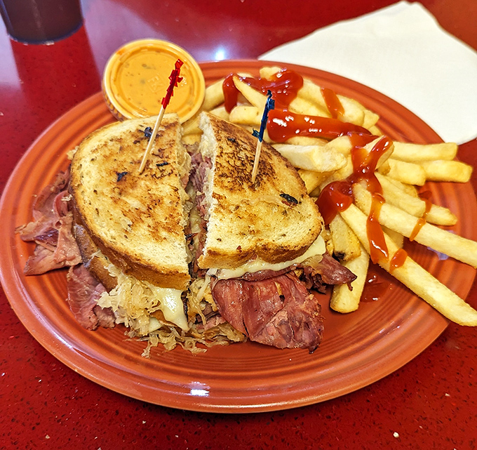 A sandwich that requires both hands and a strategy, served with fries that have achieved the perfect golden-brown graduation.