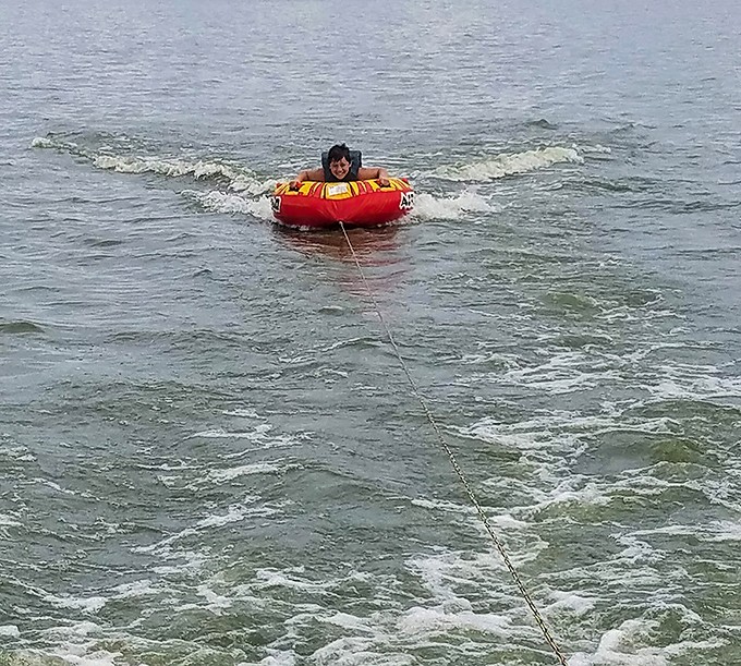 Pure joy has a face, and it's riding an inner tube across Buckeye Lake's rippling surface, creating memories that outlast summer's warmth.